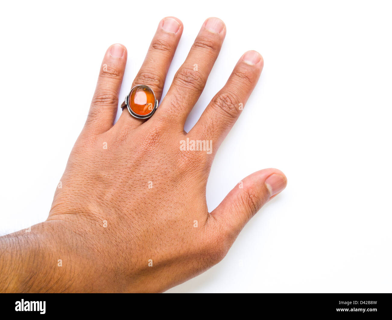 A guy hand with amber ring on his finger isolated on white background ...