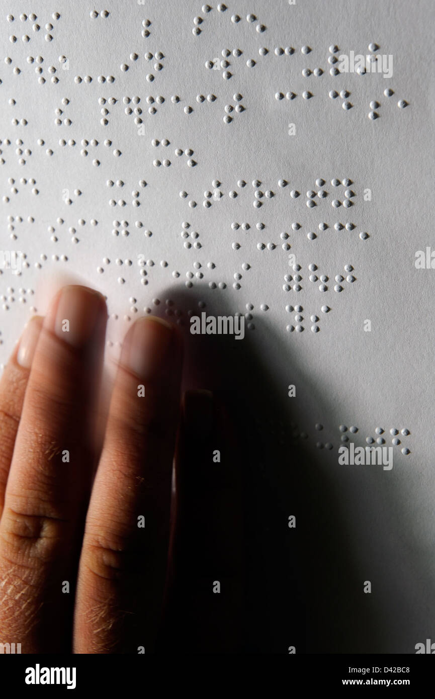 Hand reading braille Stock Photo - Alamy