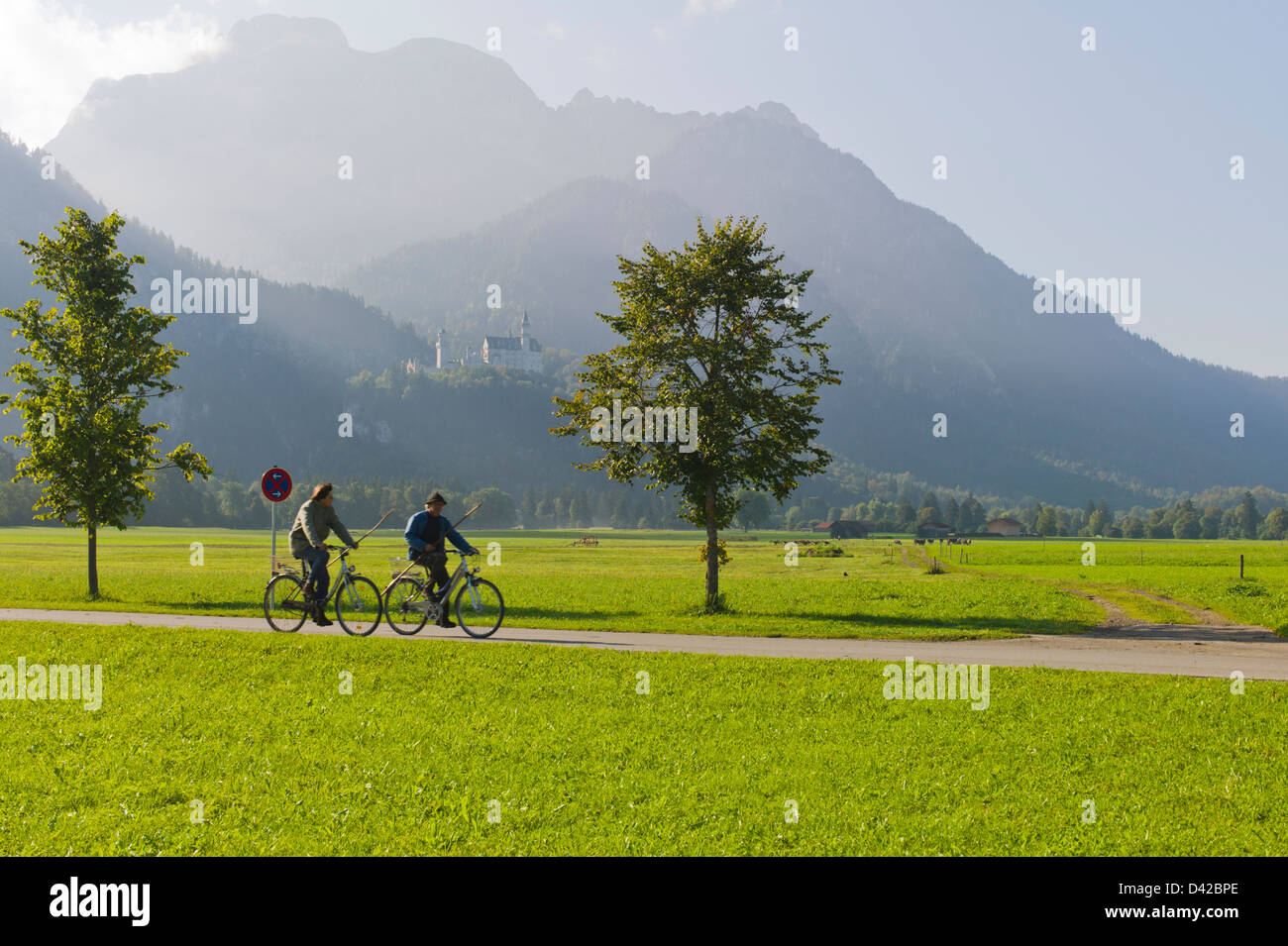 Cyclists near Neuschwanstein Castle Schwangau Bavaria Germany Stock ...