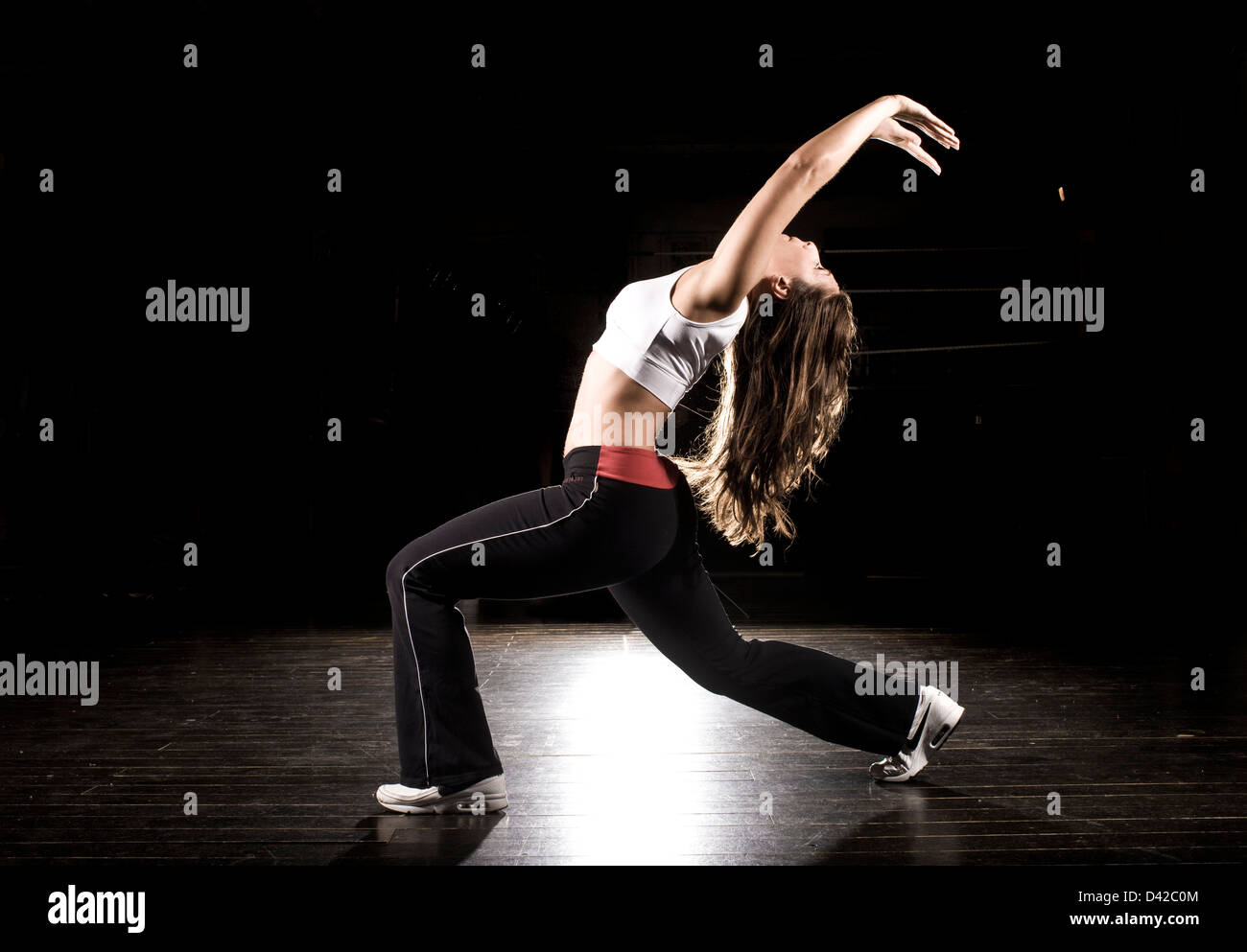 Woman stretching arms backwards in workout routine Stock Photo - Alamy
