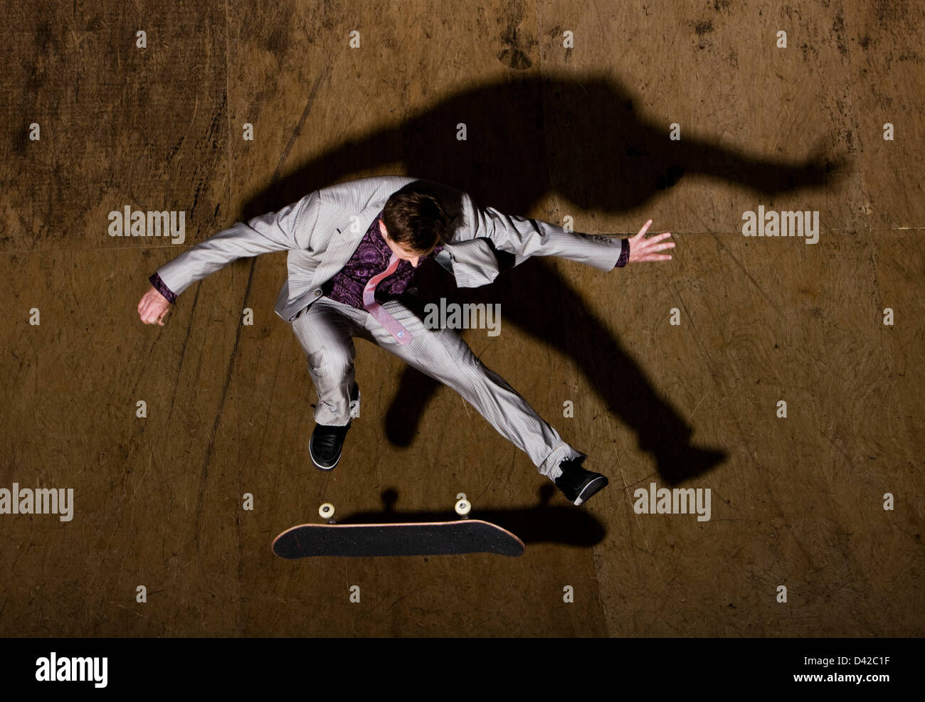 Man in suit on skateboard ramp with shadow Stock Photo - Alamy