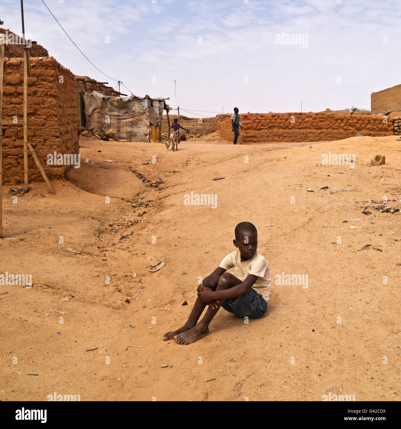 Boy sits in a street in Agadez, Niger Stock Photo - Alamy