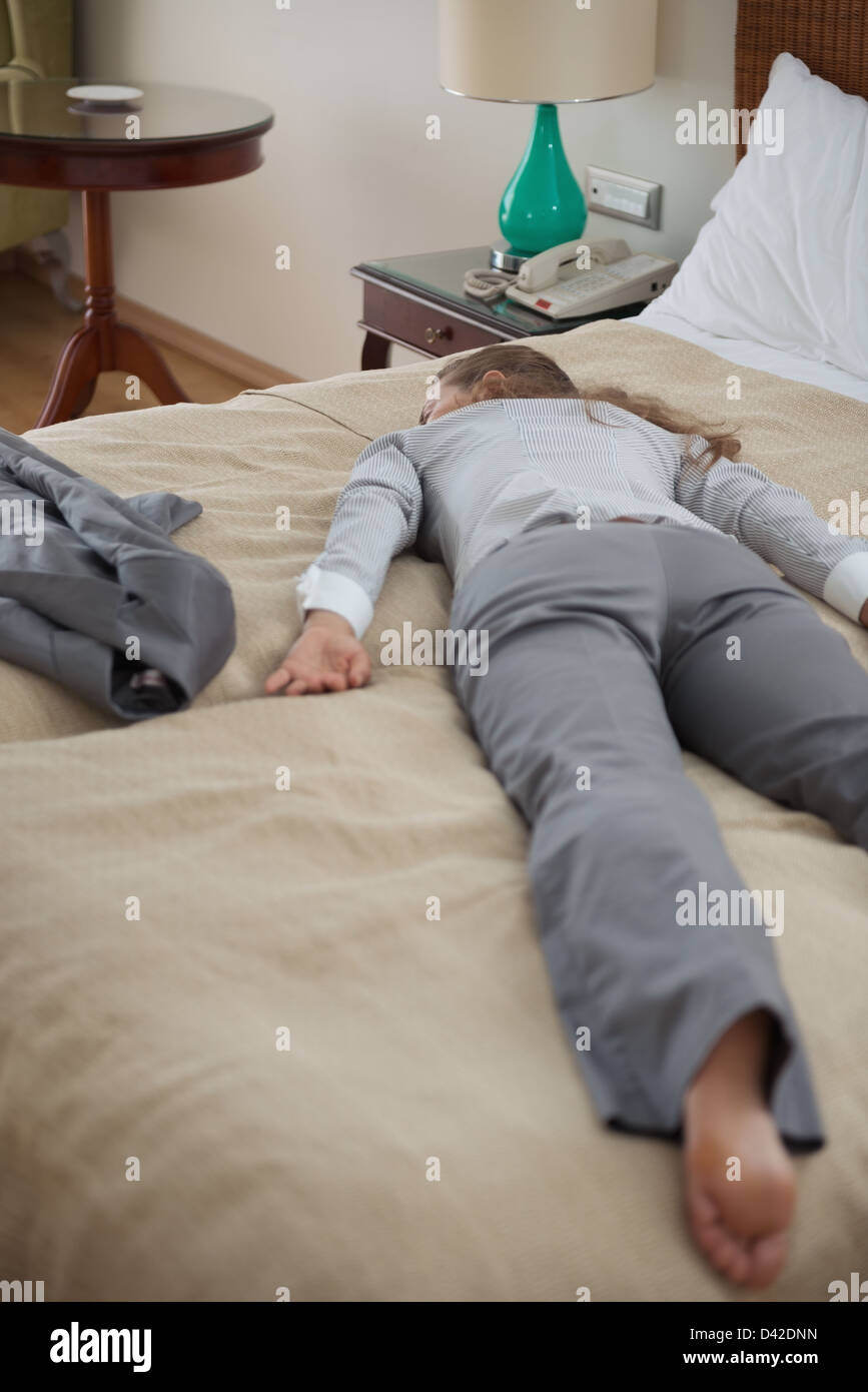 Tired business woman fall down from exhaustion in hotel room Stock ...