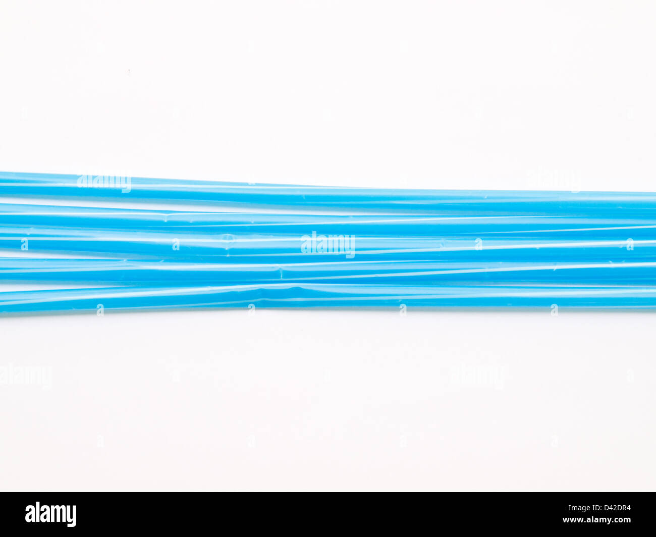 Light blue straws isolated on white background Stock Photo - Alamy