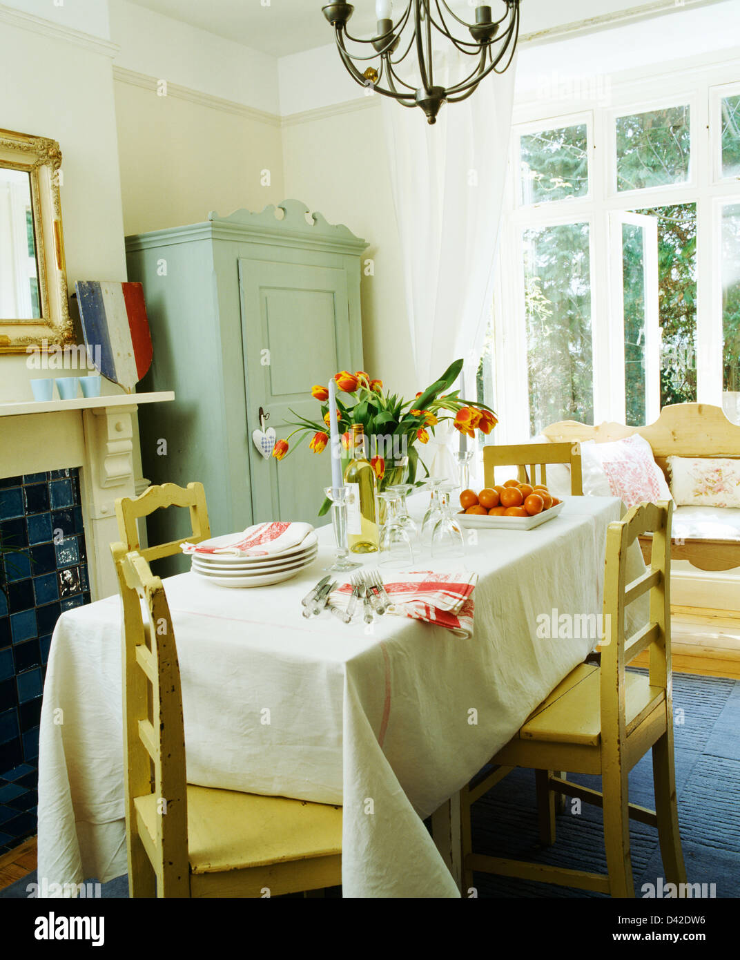 Linen cloth on table in country dining room with pale turquoise ...