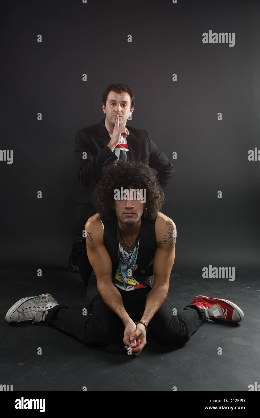 Man sitting on the floor, with another man behind him Stock Photo - Alamy
