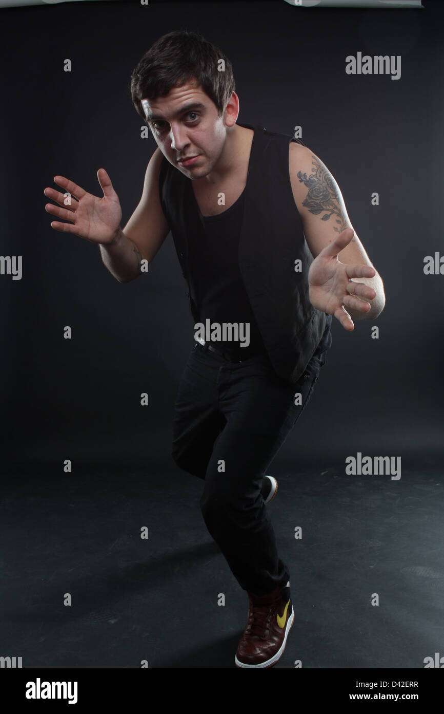 Man leaning forward towards the camera, waving his hands Stock Photo ...