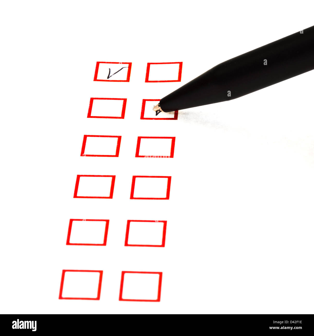 put tick in red square box by black ballpoint Stock Photo - Alamy