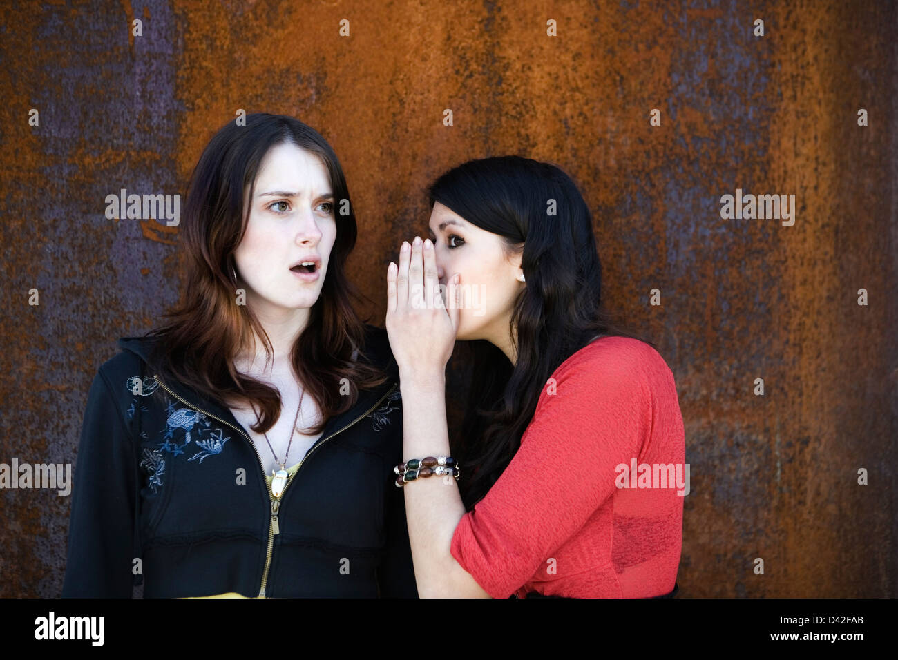 Teens whispering shocked hi-res stock photography and images - Alamy