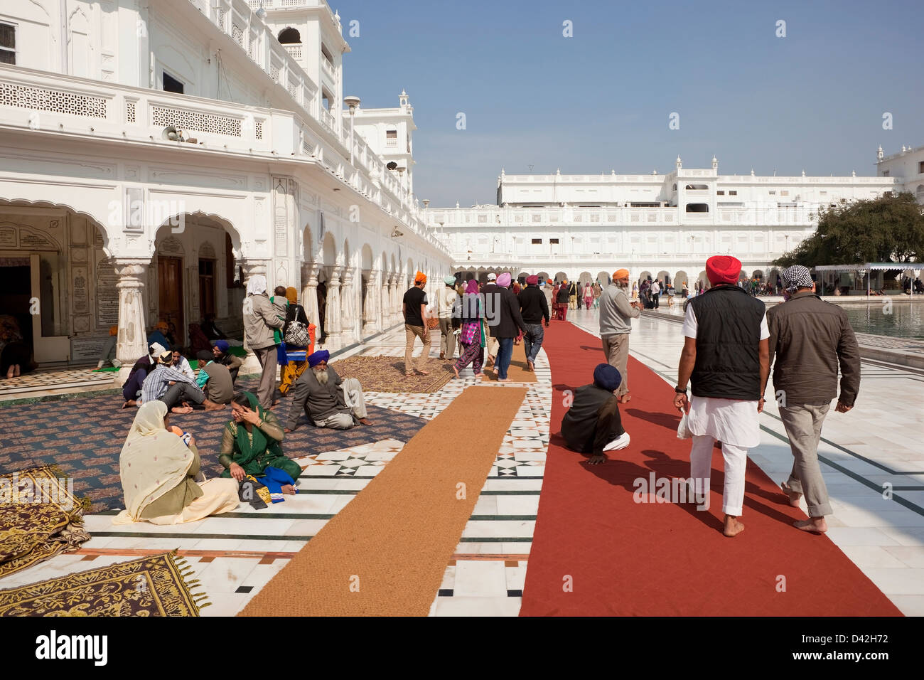 A colorful community crowd scene at the Golden Temple complex in ...
