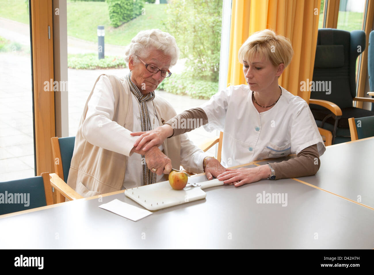 Essen, Germany, a geriatric nurse helps a stroke patient at ...