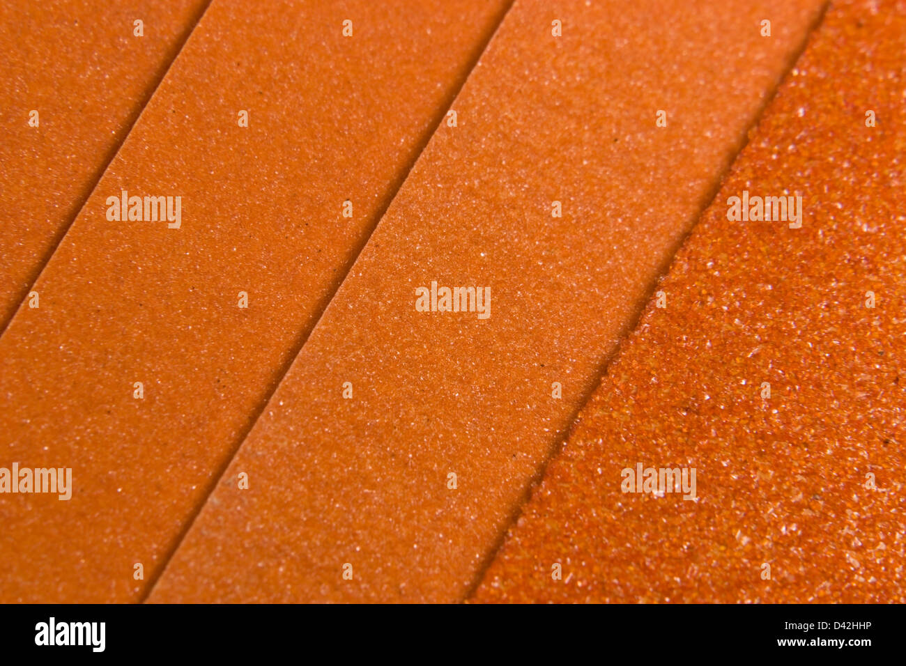 abstract background showing some orange colored sandpaper in various ...