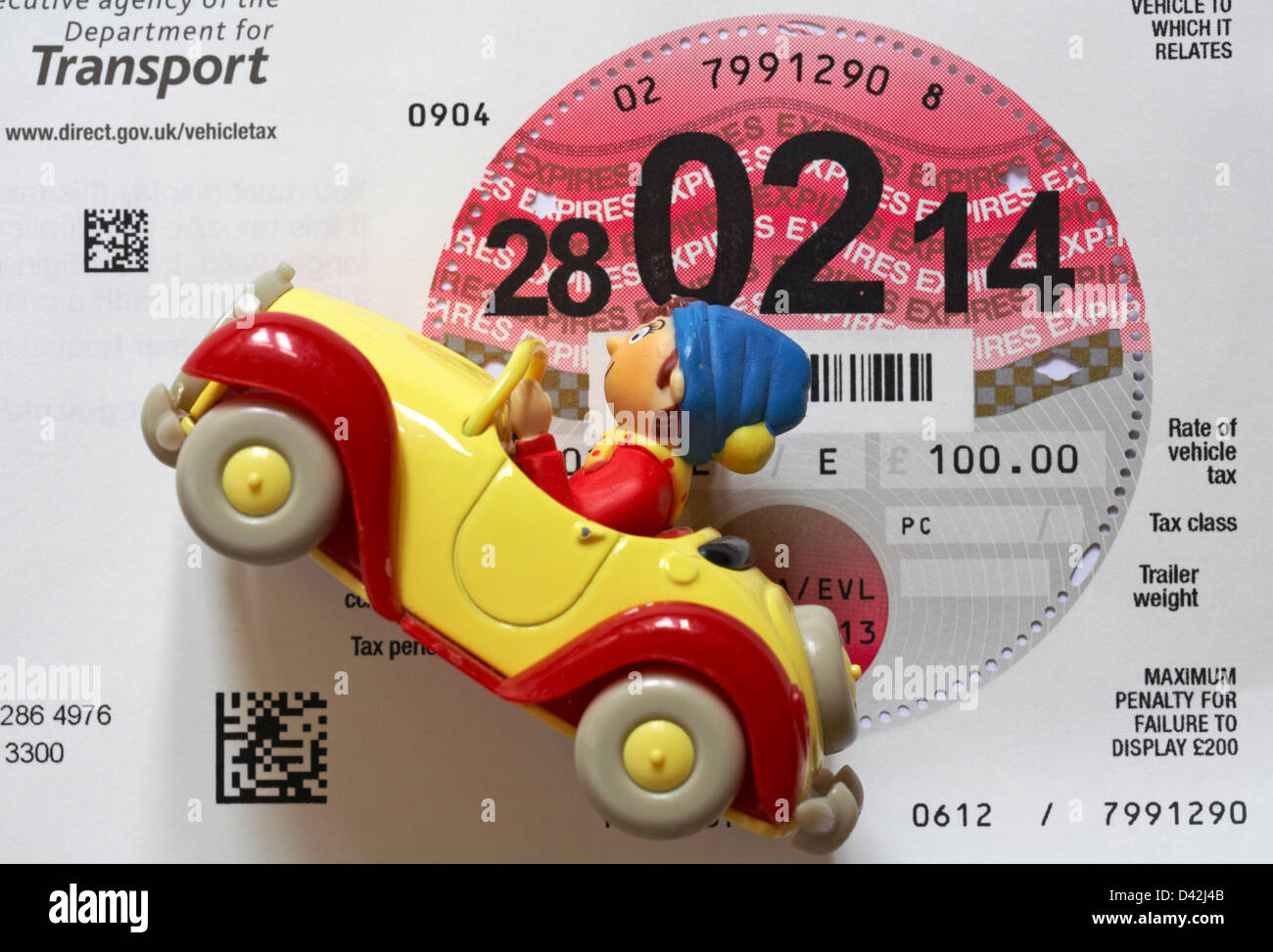 car tax disc and model toy noddy car Stock Photo - Alamy
