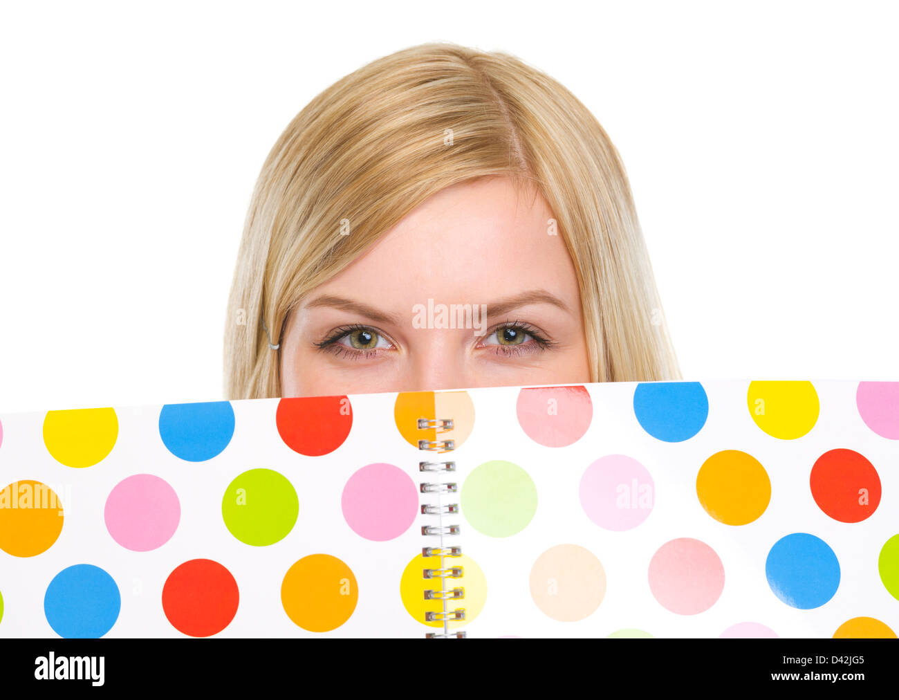 Closeup on student girl hiding behind notebook Stock Photo - Alamy