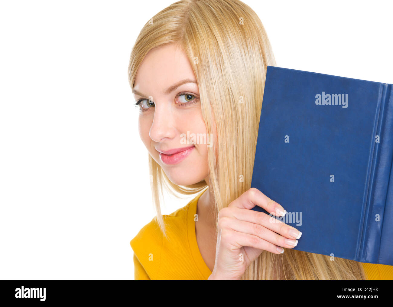 Happy student girl looking out from book Stock Photo - Alamy