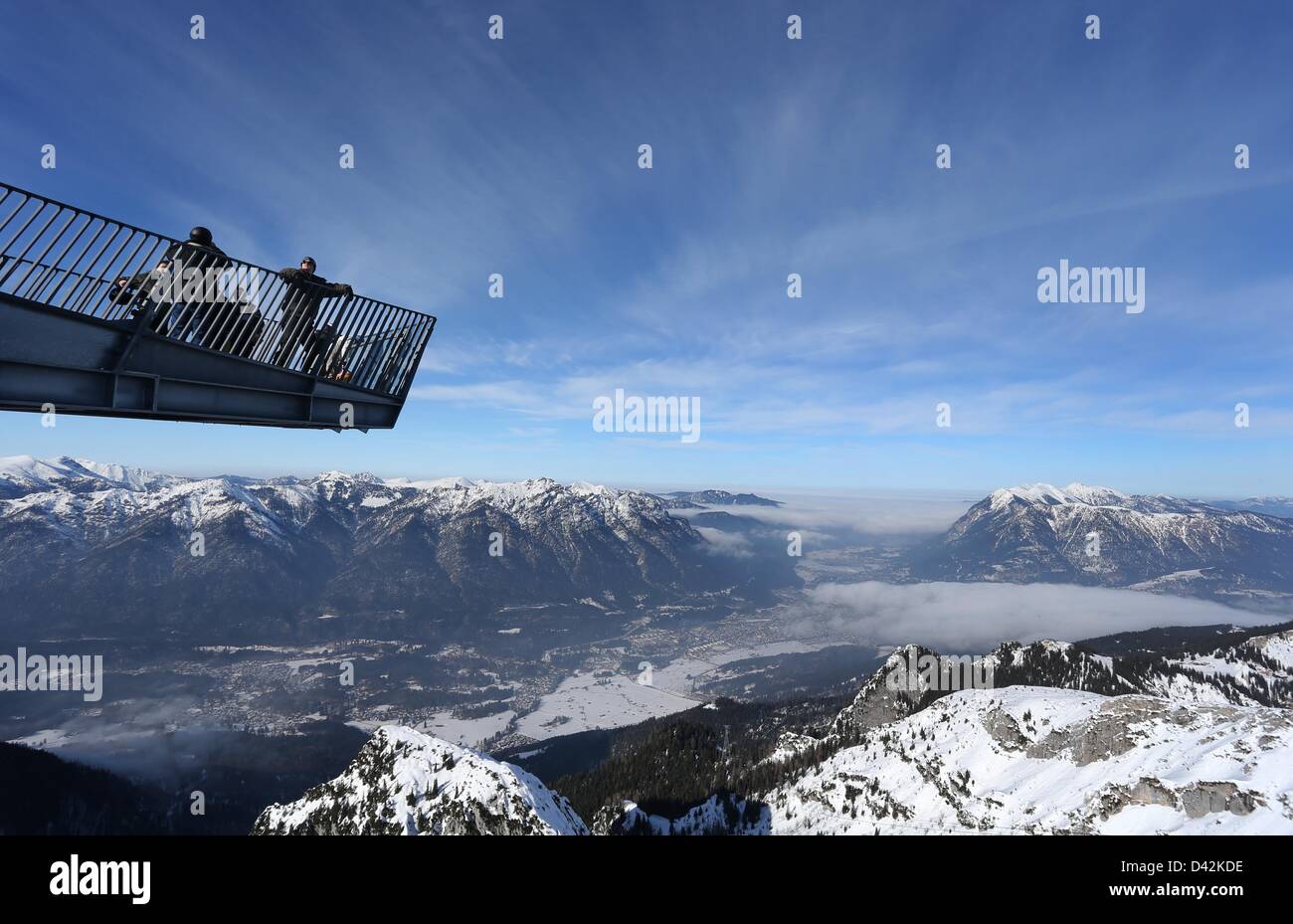 A tourist enjoys the sun on the panorama platform 'Alpspix' on the ...