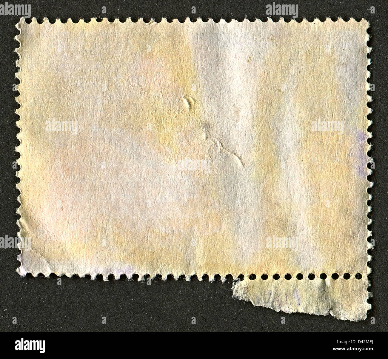 The reverse side of a postage stamp Stock Photo - Alamy