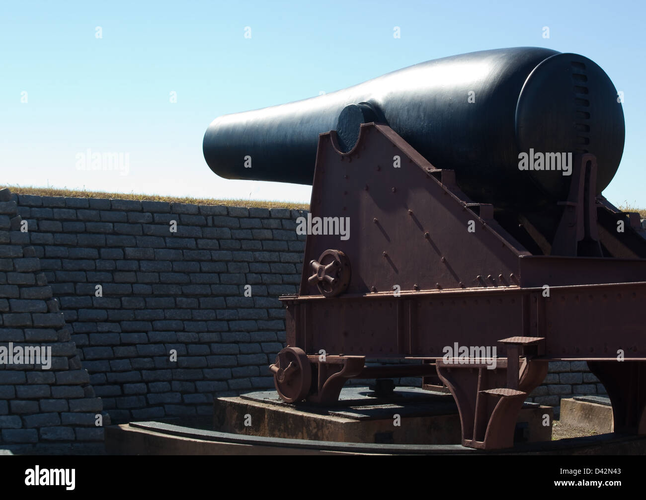 Cannon looking out over a wall in bright sunshine Stock Photo - Alamy