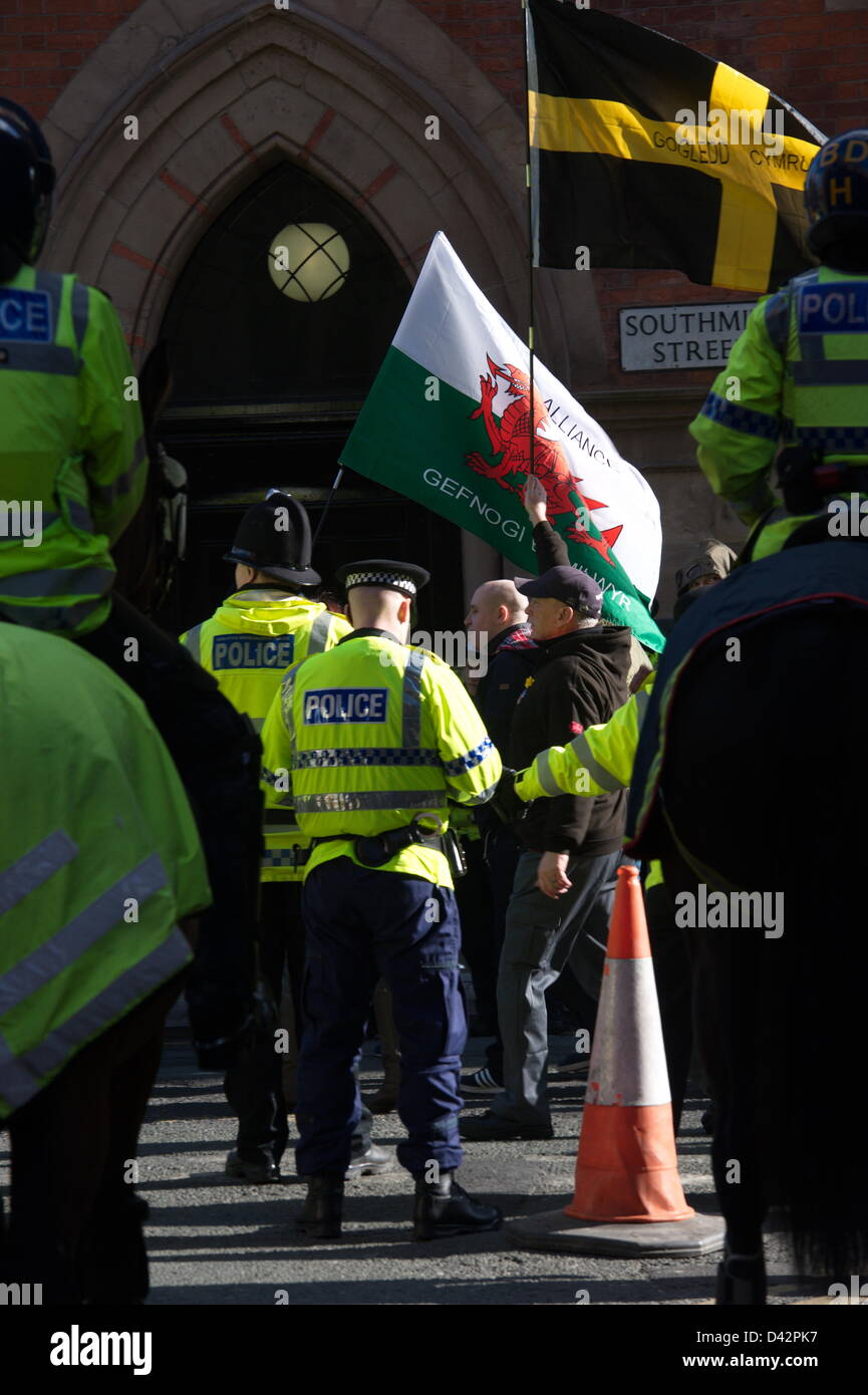 EDL supporters arrive at Albert Square holding a Welsh flag ...