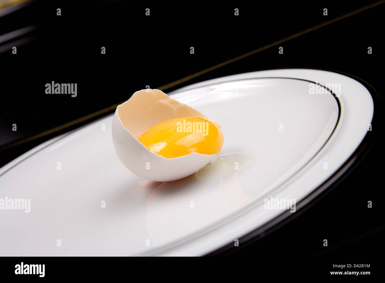 Berlin, Germany, opened a raw egg on a plate Stock Photo - Alamy