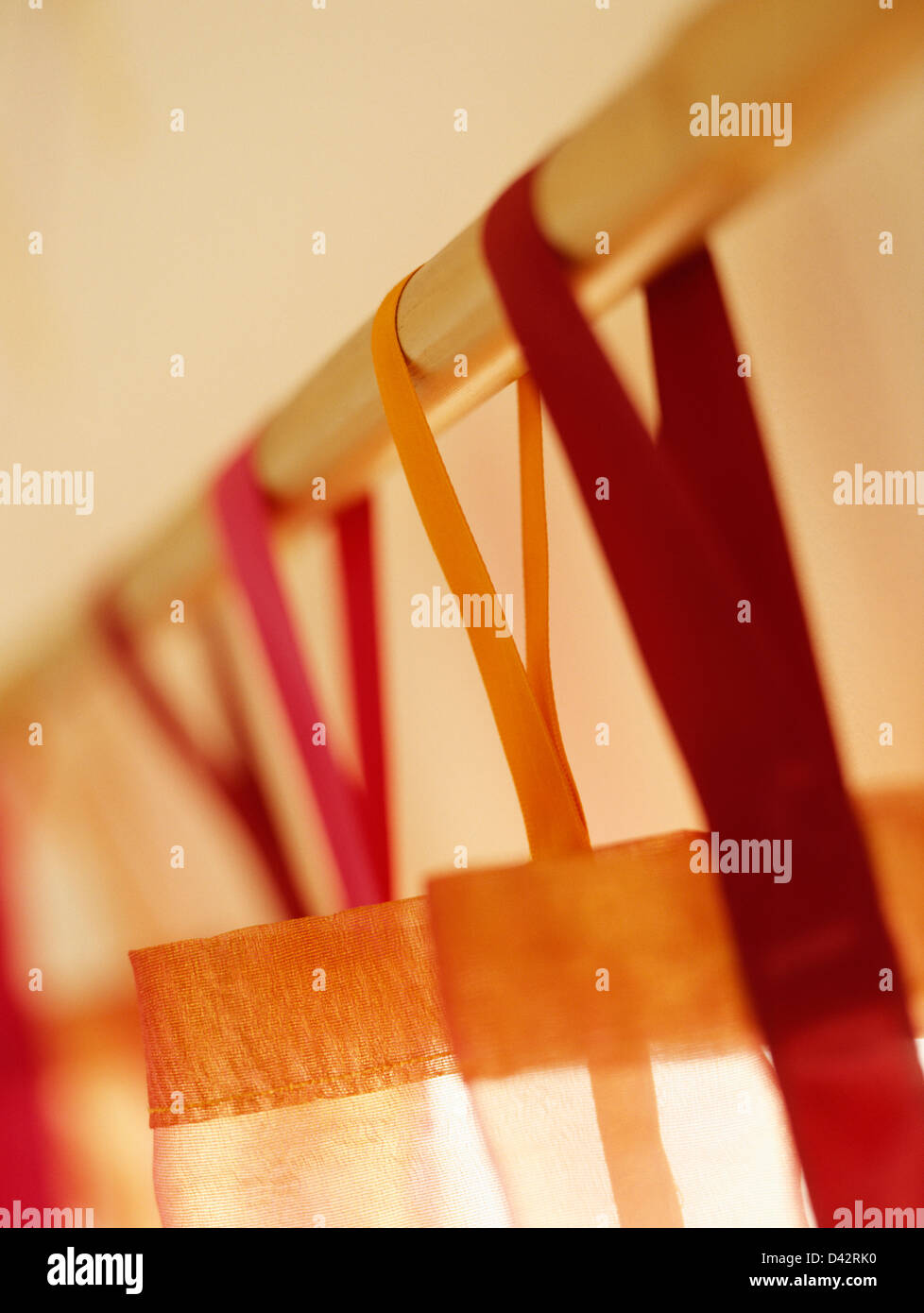 Close-up of tab voile curtain on wooden pole Stock Photo - Alamy