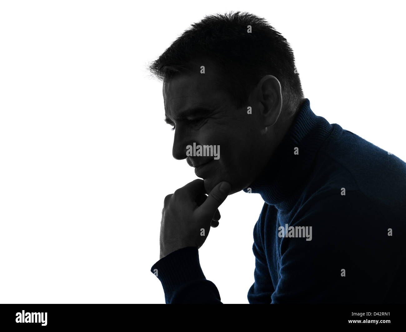one man serious thinking pensive portrait in silhouette studio isolated ...