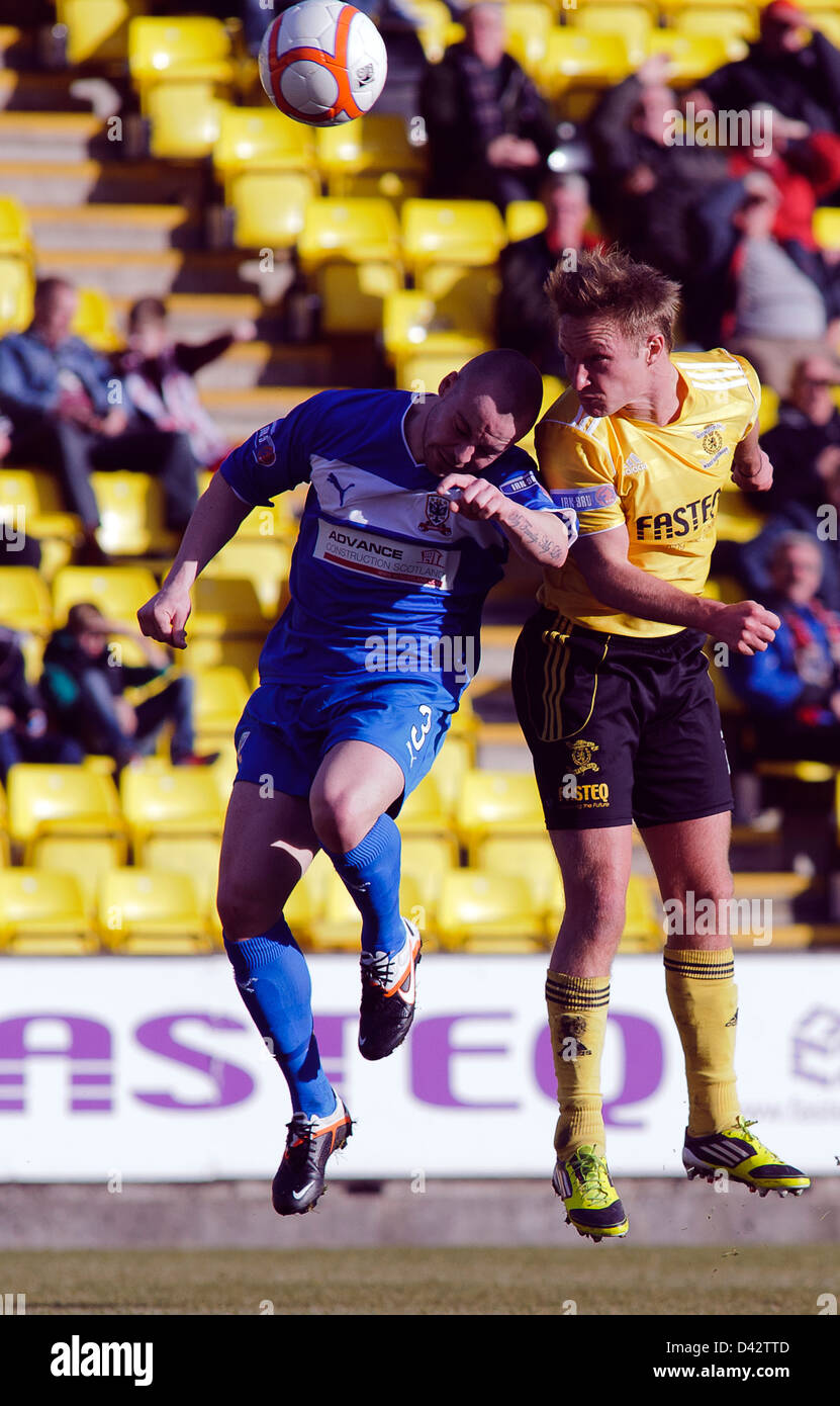 Iain Russell gets a header on goal as Marc Warren (3) challenges Stock ...