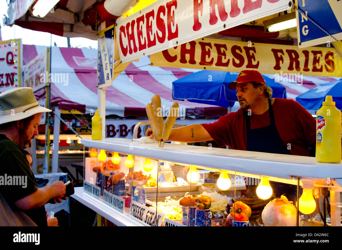 Man buying corn dog from food stall at dusk, Blue Hill Fair, Maine ...