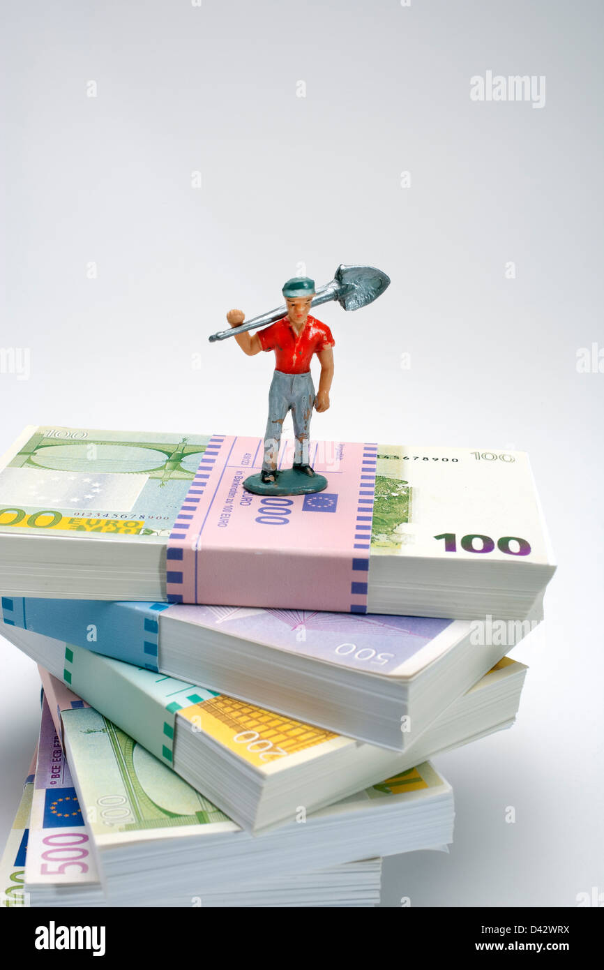 Freiburg, Germany, workers figure stands on a stack of euro notes Stock ...