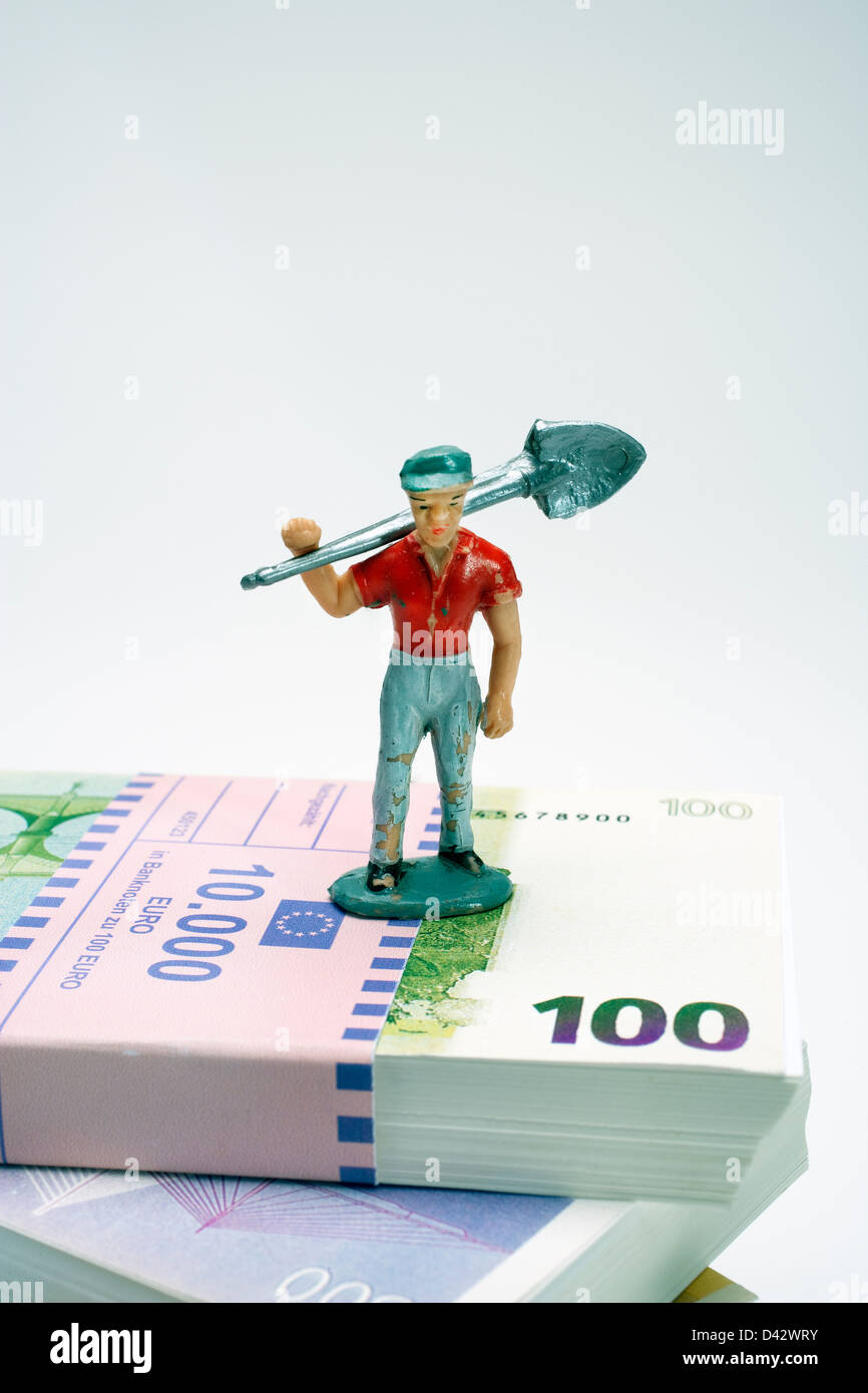 Freiburg, Germany, workers figure stands on a stack of euro notes Stock ...