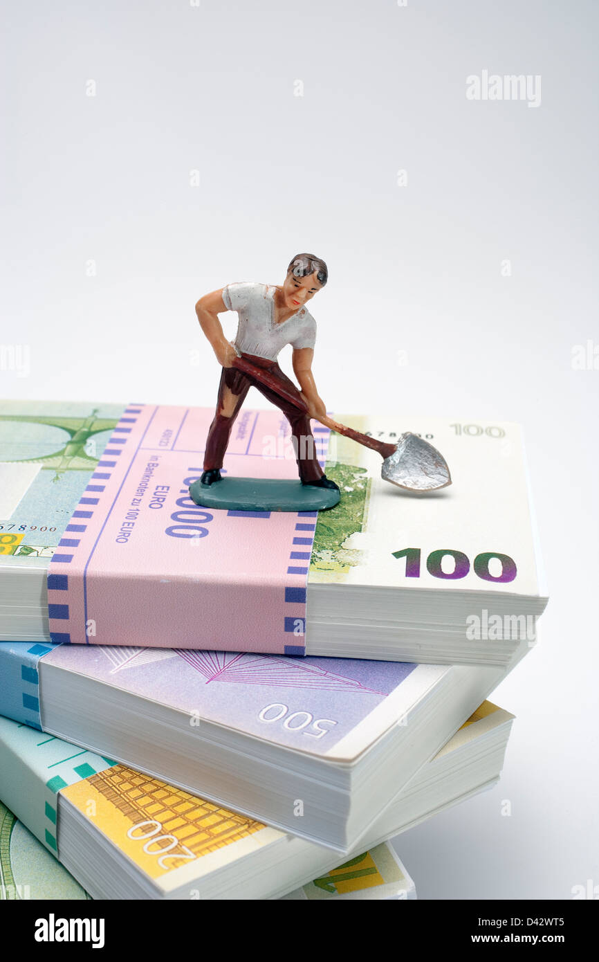 Freiburg, Germany, workers figure stands on a stack of euro notes Stock ...