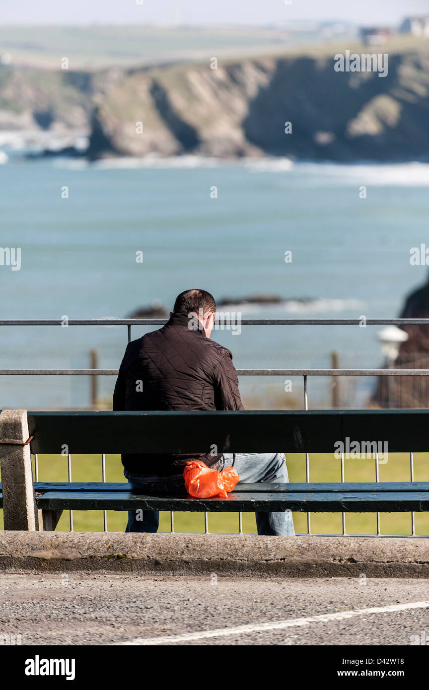 A man sitting on a bench Stock Photo - Alamy