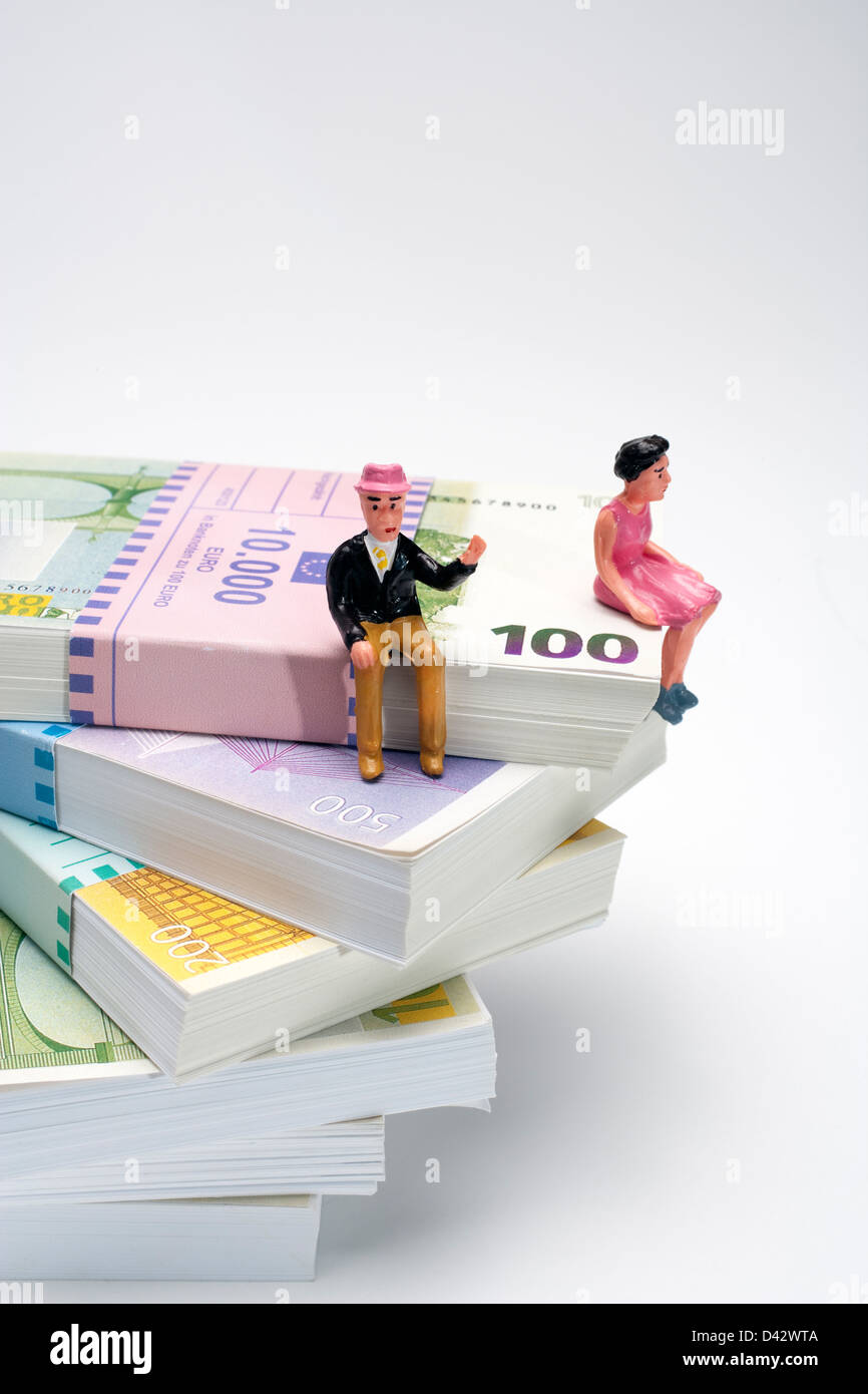 Freiburg, Germany, retiree figures sitting on a stack of euro notes ...