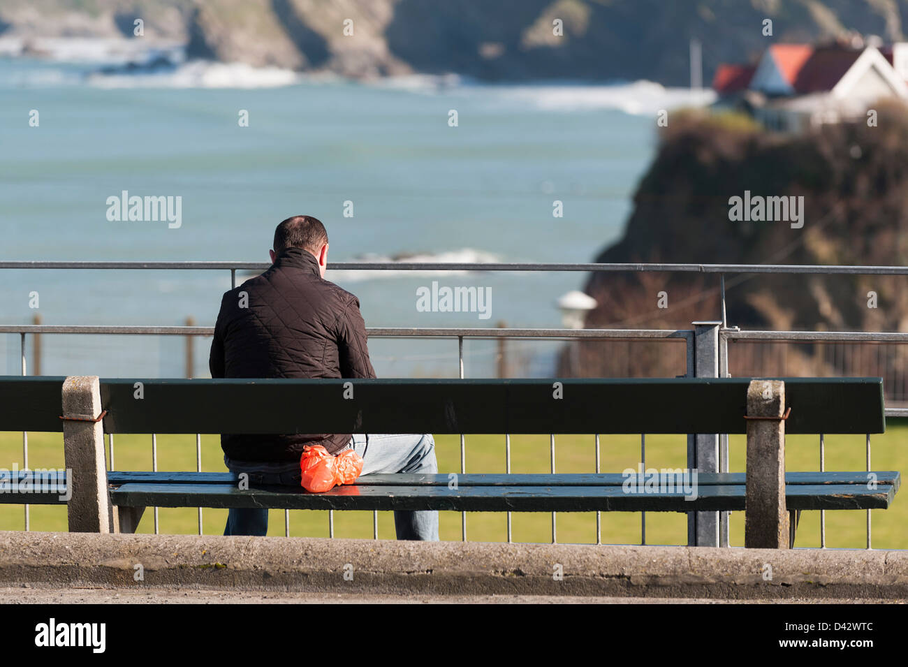 A man sitting on a bench Stock Photo - Alamy