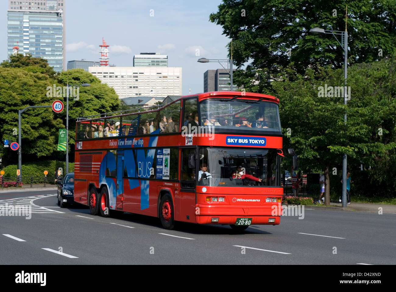 An open top double-decker tour bus loaded with tourists making it ...