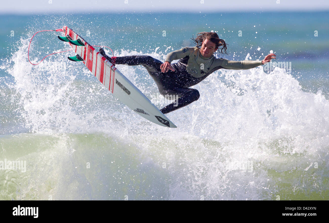 Male surfer in Wet Suit doing cool tricks Stock Photo - Alamy