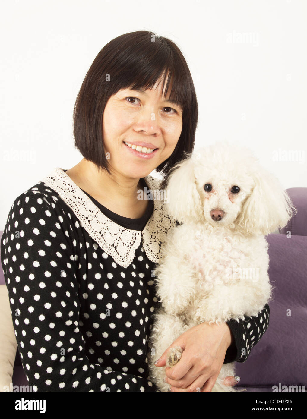 Woman holding poodle hi-res stock photography and images - Alamy