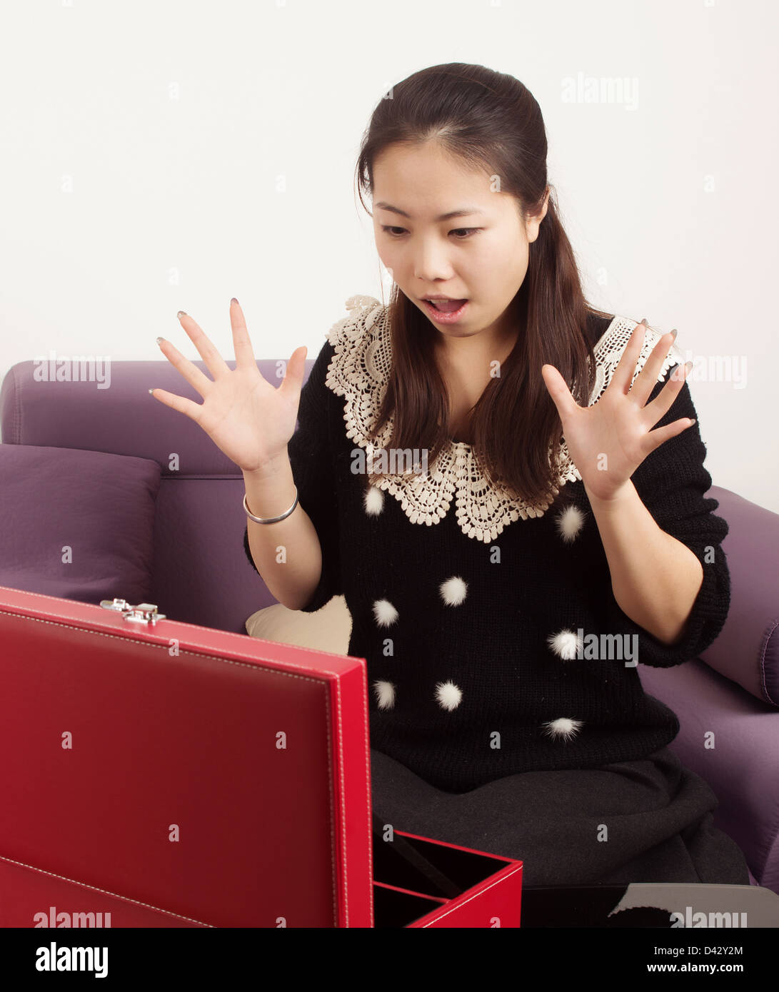 In the face of the box made surprised expression girl Stock Photo - Alamy