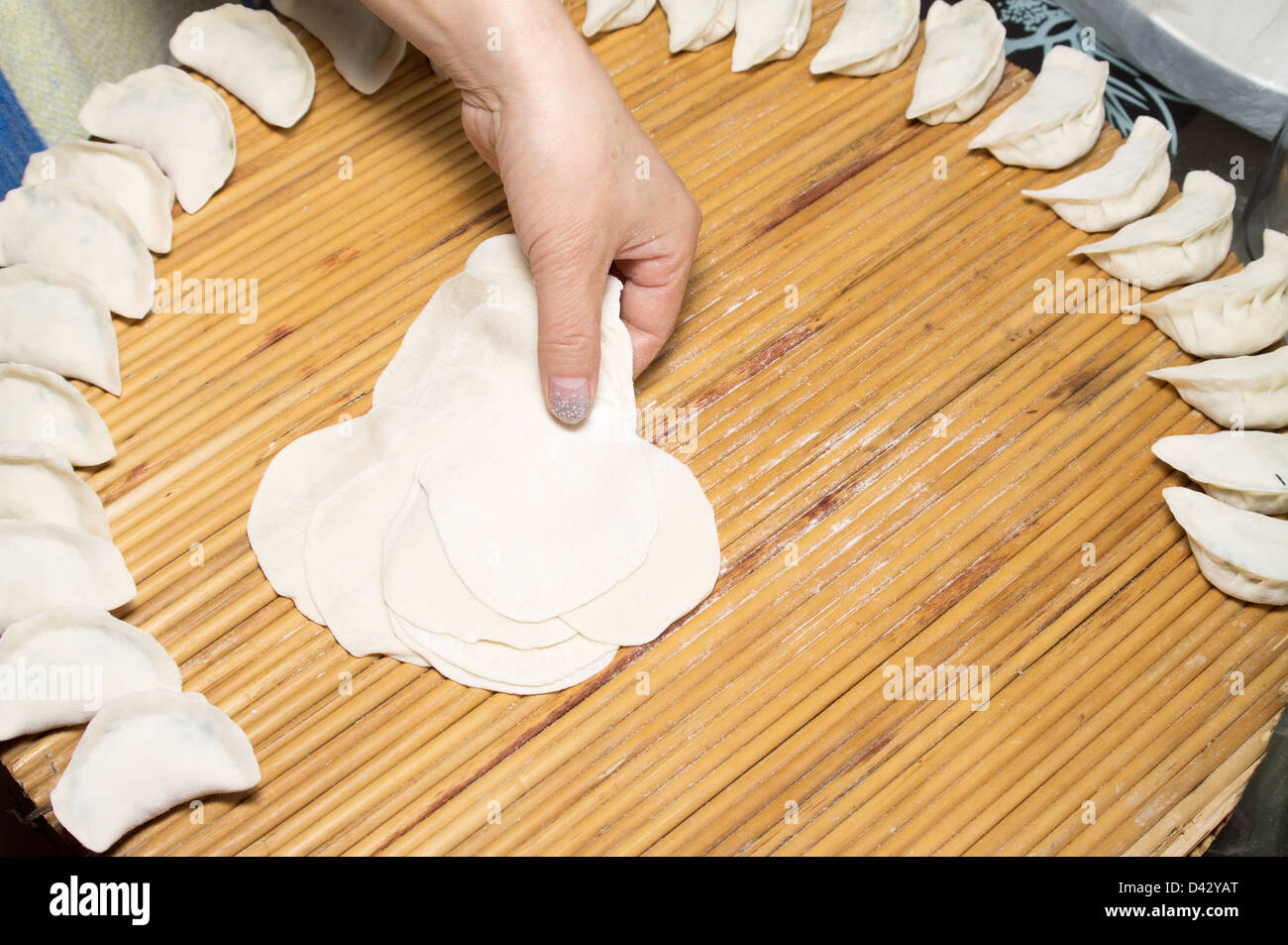 Woman's hand and Chinese cuisine dumplings Stock Photo - Alamy