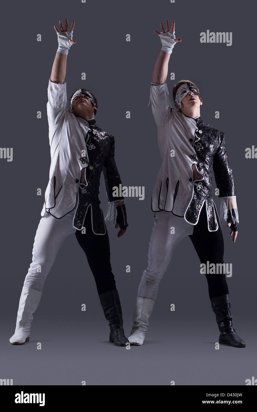 Two dancers in costumes and masks Stock Photo - Alamy
