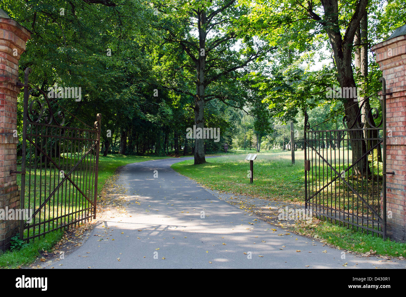 large antique gate open into the park Stock Photo - Alamy