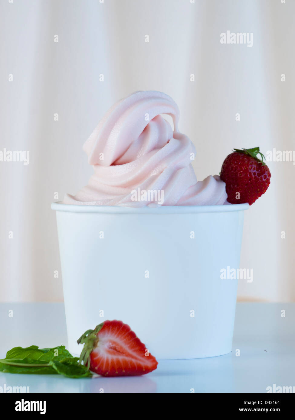 Cup of strawberry frozen yogurt or soft serve ice cream with fresh ...