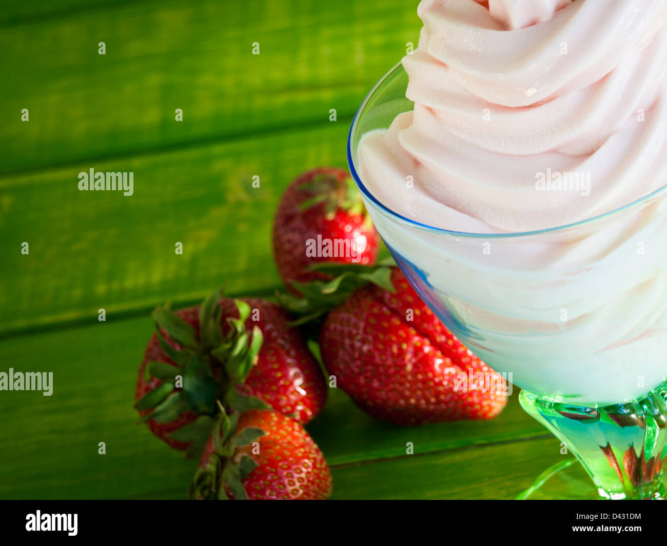Cup of strawberry frozen yogurt or soft serve ice cream with fresh ...