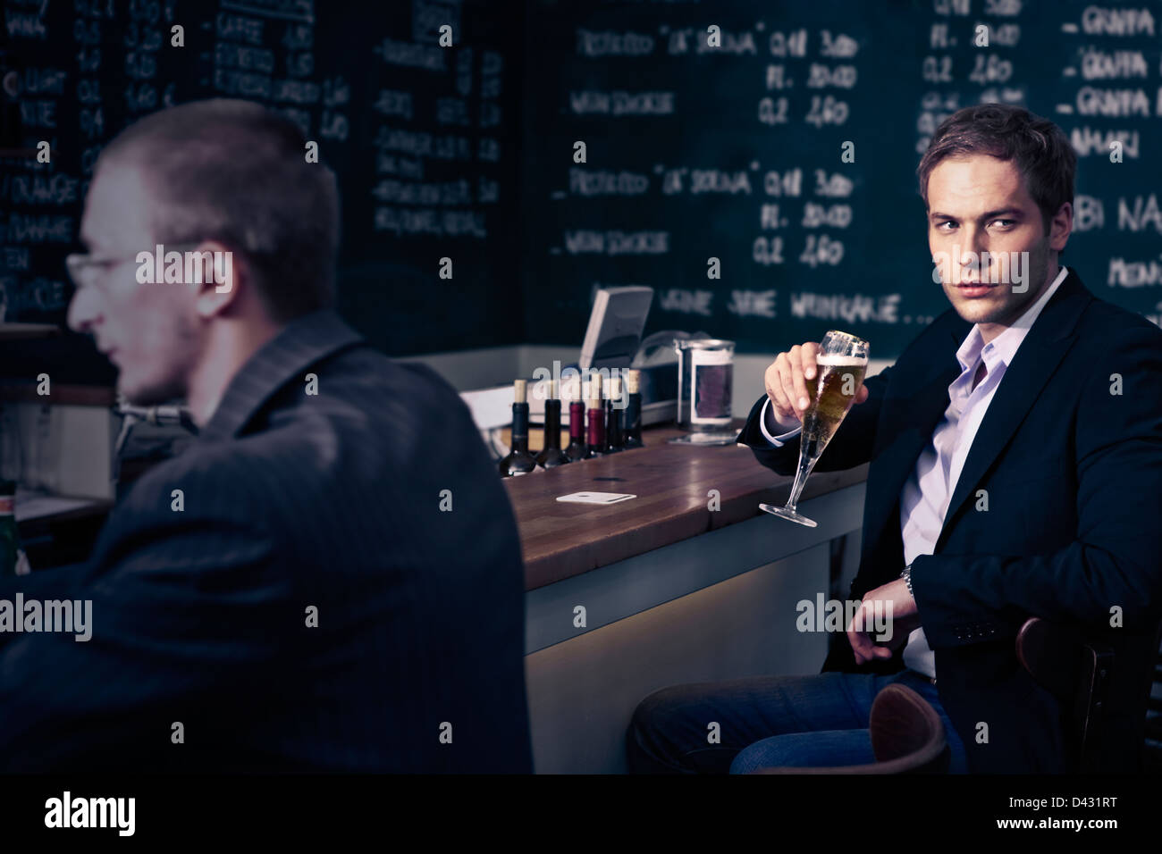 A handsome young man scanning the room, checking out the crowd, on the ...