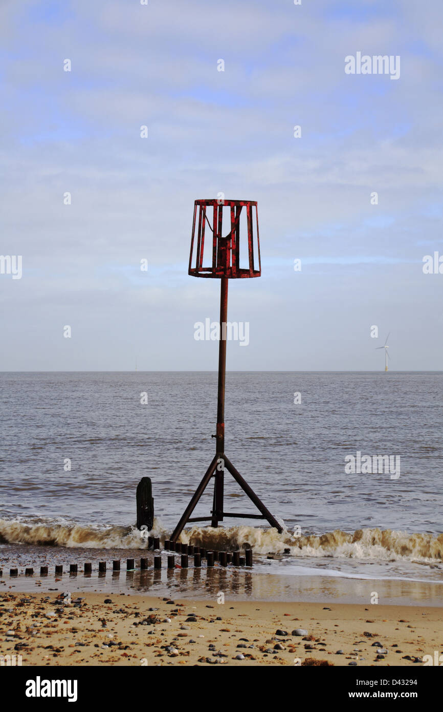A groyne marker post and offshore wind turbine at Caister-on-Sea ...