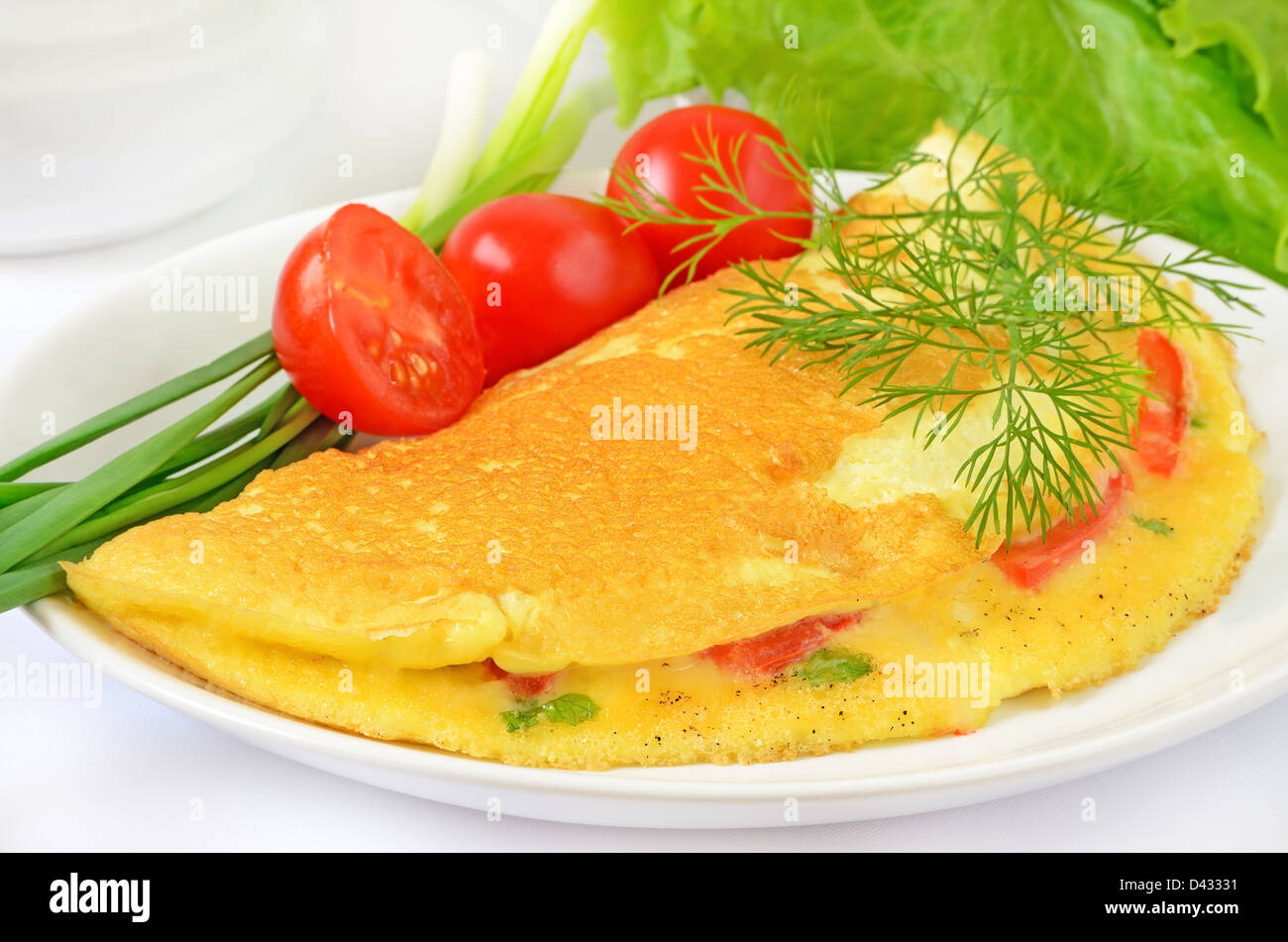 Omelet with herbs and vegetables on the plate Stock Photo - Alamy