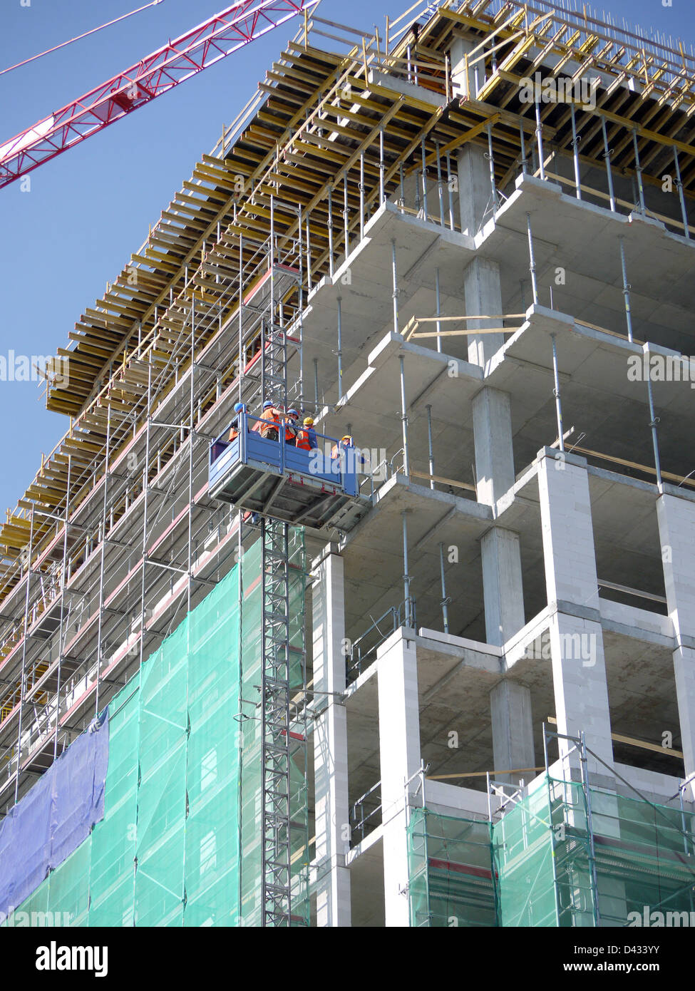 Group of construction workers going up the multistorey building using ...