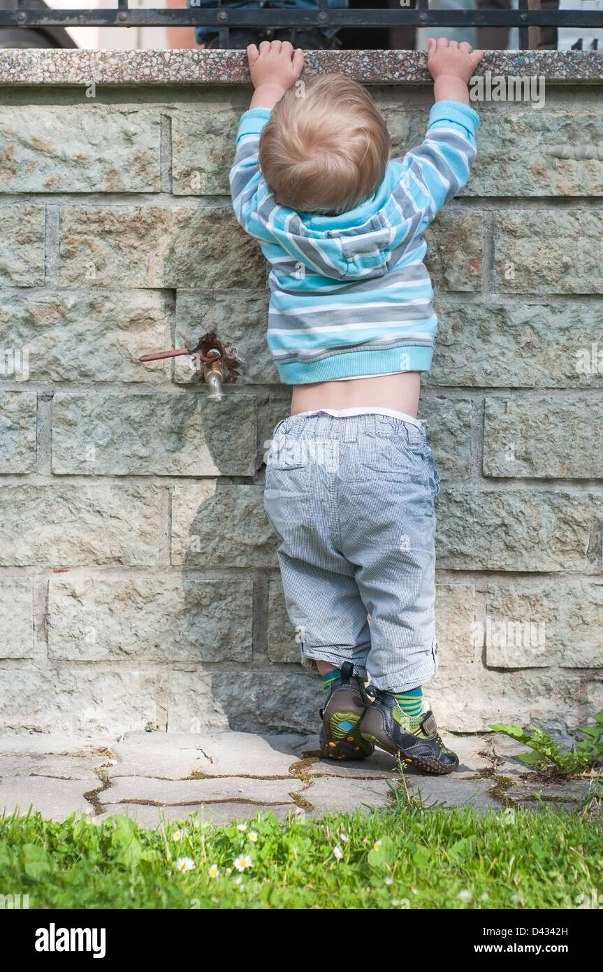 Baby boy in grey and blue making pull-ups Stock Photo - Alamy