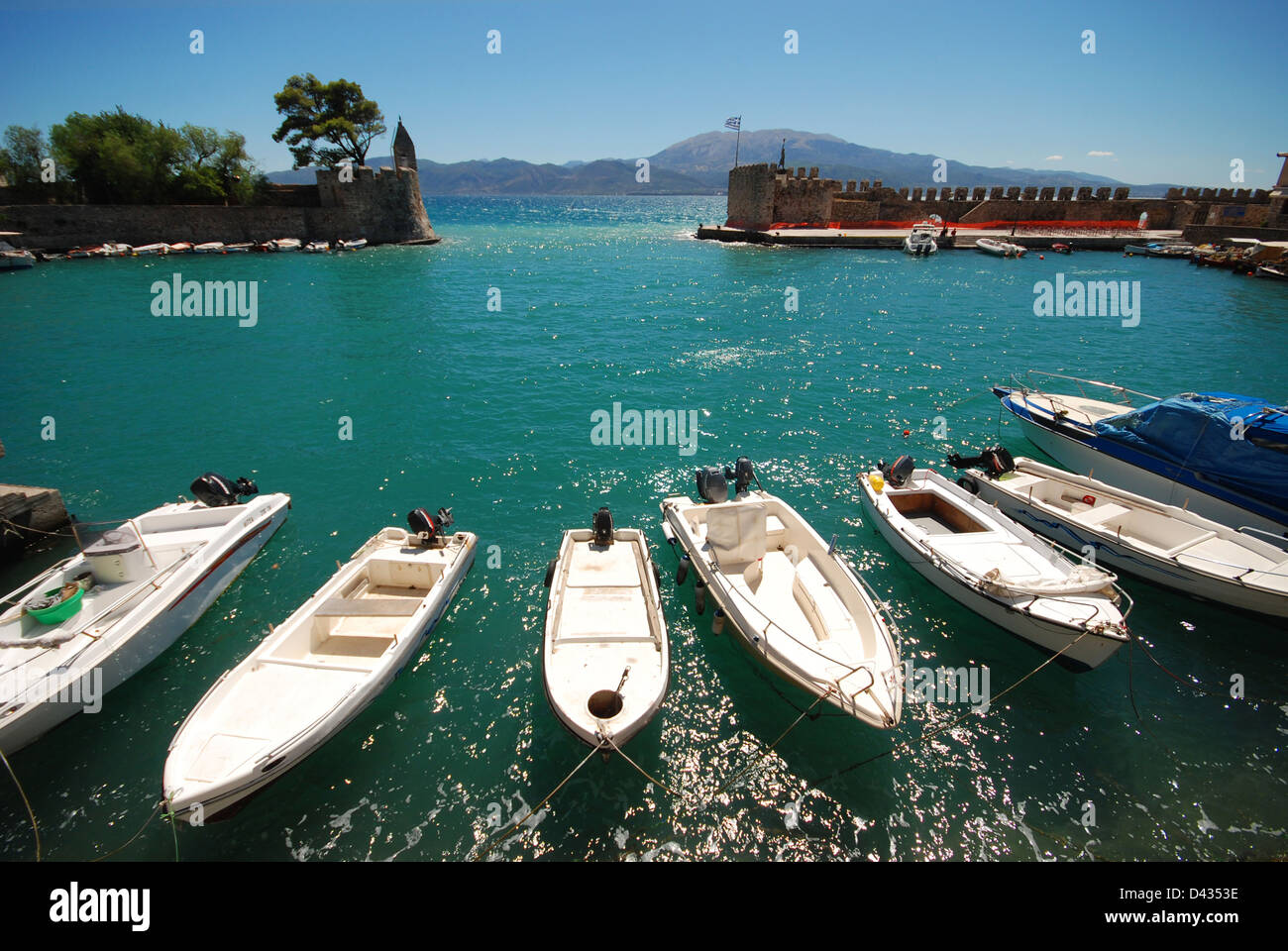 Nafpaktos harbour in Greece, with boats in the foreground, and the Gulf ...