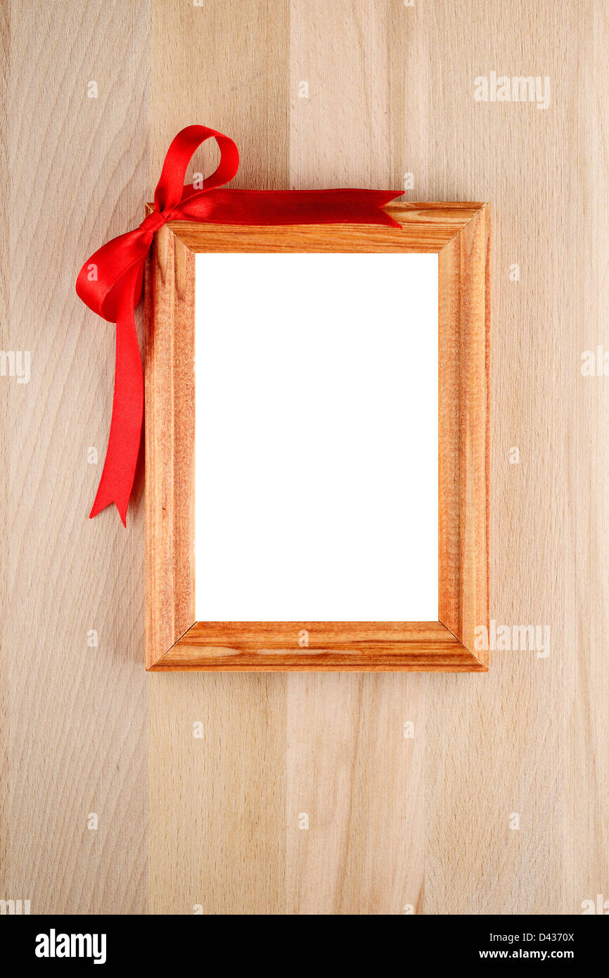 Photo frame with red bow on wood Stock Photo - Alamy